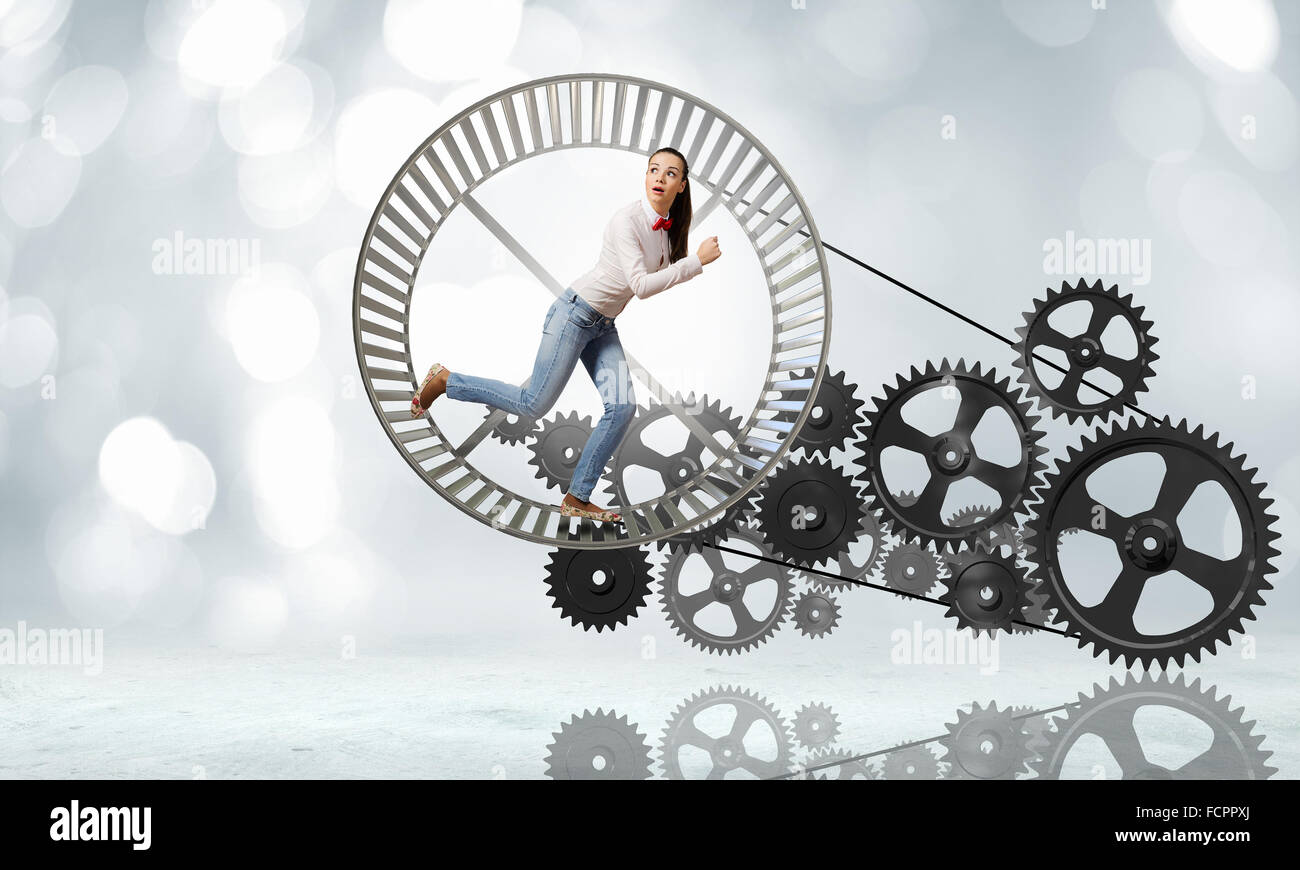Young businesswoman running in wheel of gears mechanism Stock Photo - Alamy