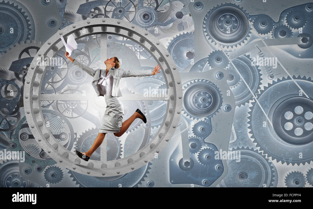 Young businesswoman running in wheel of gears mechanism Stock Photo - Alamy