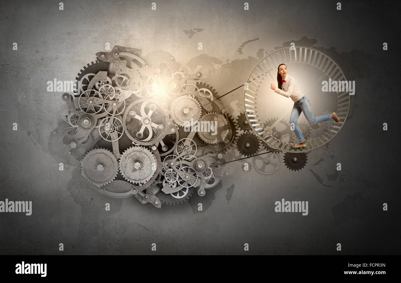 Young businesswoman running in wheel of gears mechanism Stock Photo - Alamy