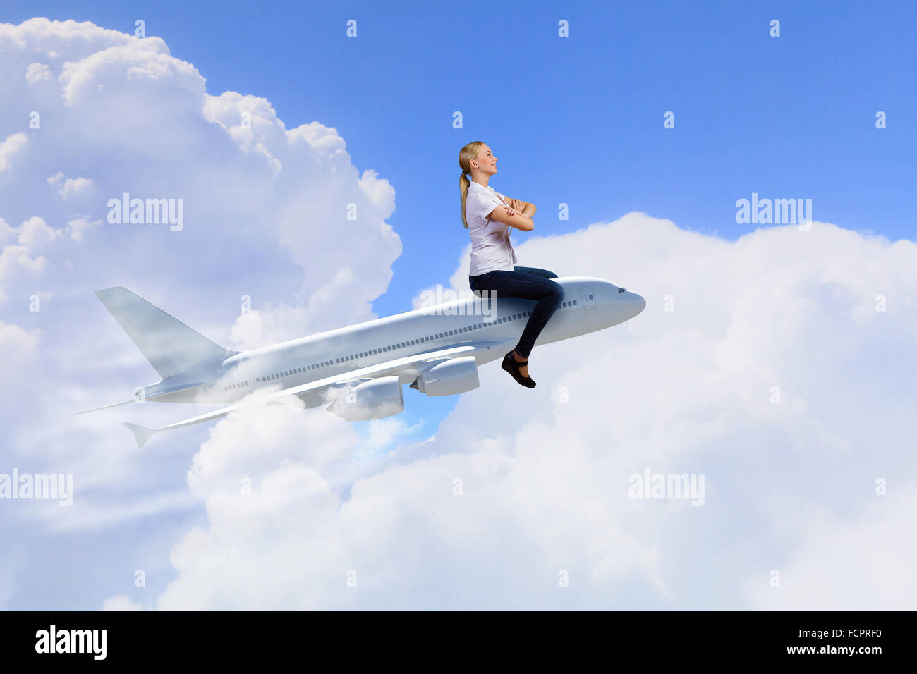 Young woman riding drawn airplane flying in air Stock Photo - Alamy