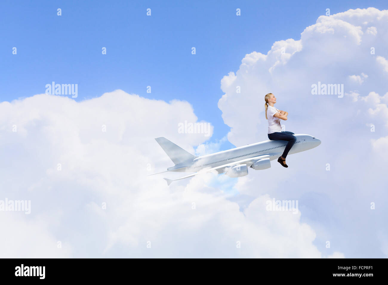 Young woman riding drawn airplane flying in air Stock Photo - Alamy