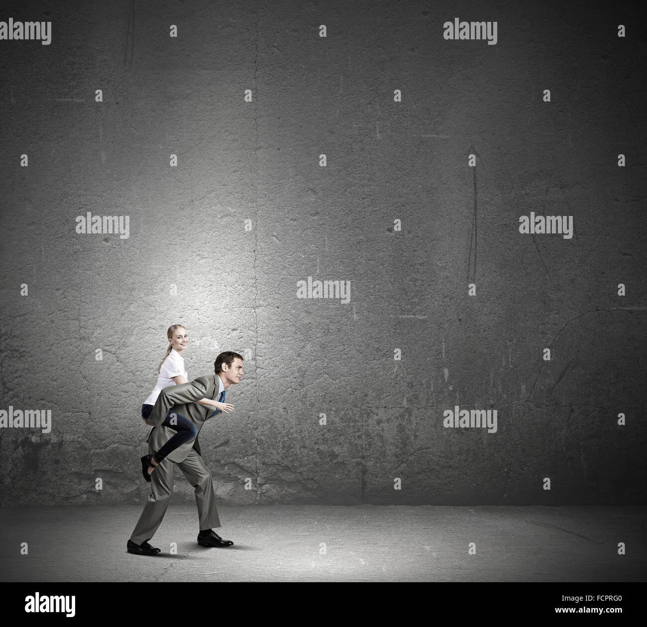 Young girl riding on back of her man Stock Photo - Alamy