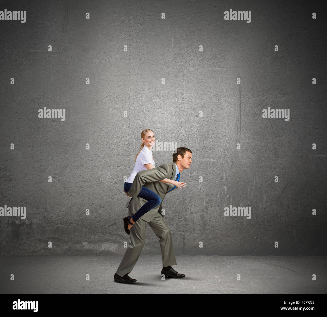 Young girl riding on back of her man Stock Photo - Alamy