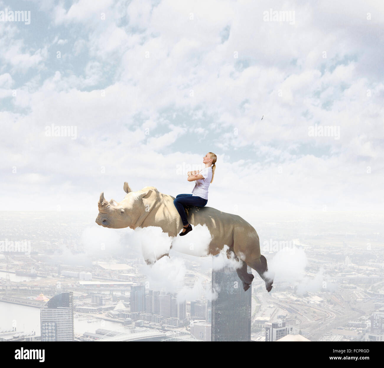 Young pretty fearless woman riding huge flying Stock Photo - Alamy