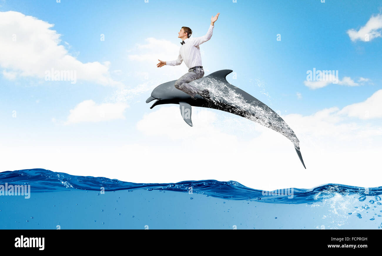 Man riding dolphin hi-res stock photography and images - Alamy