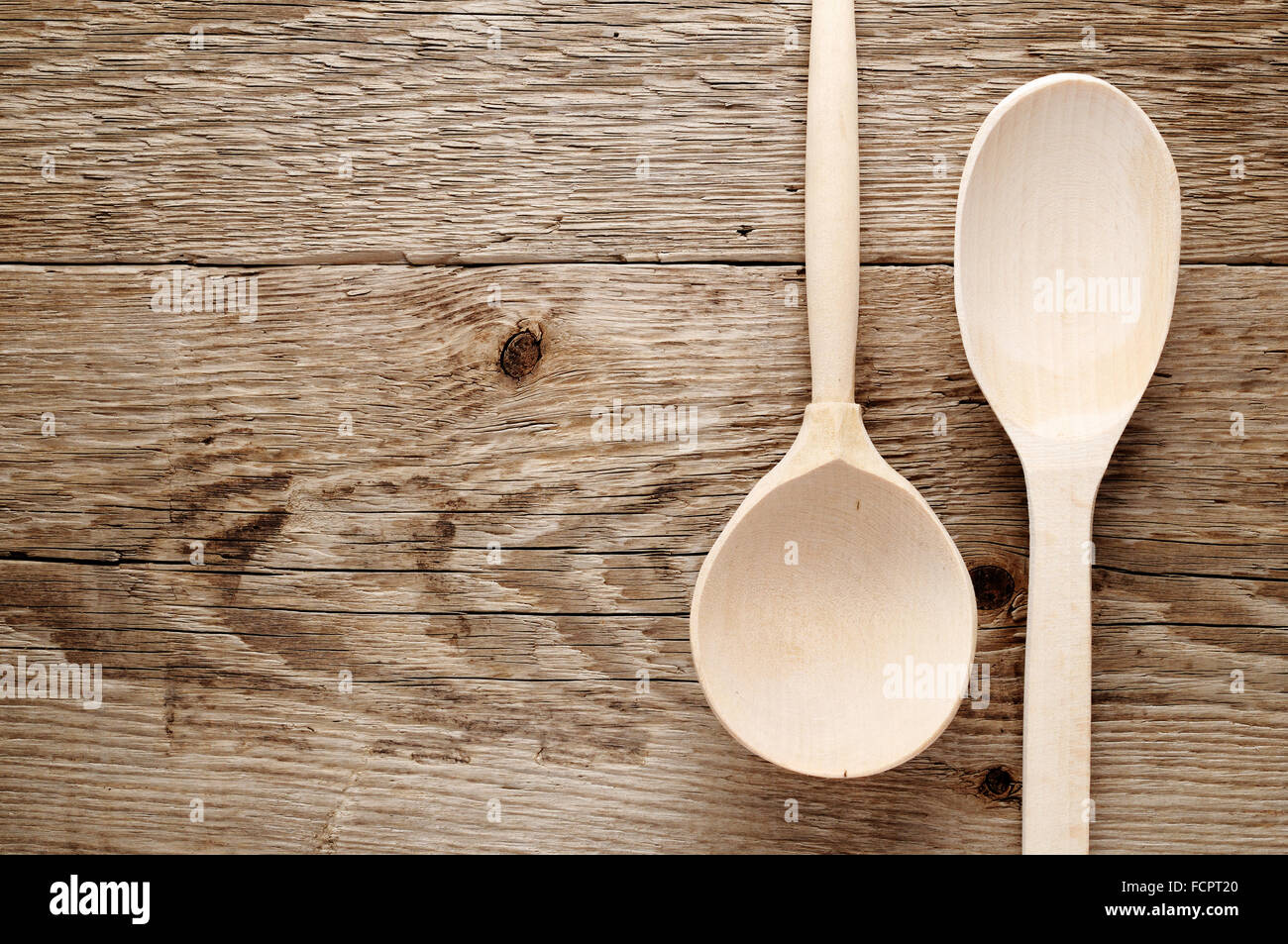 Two wooden spoons on table top view Stock Photo - Alamy