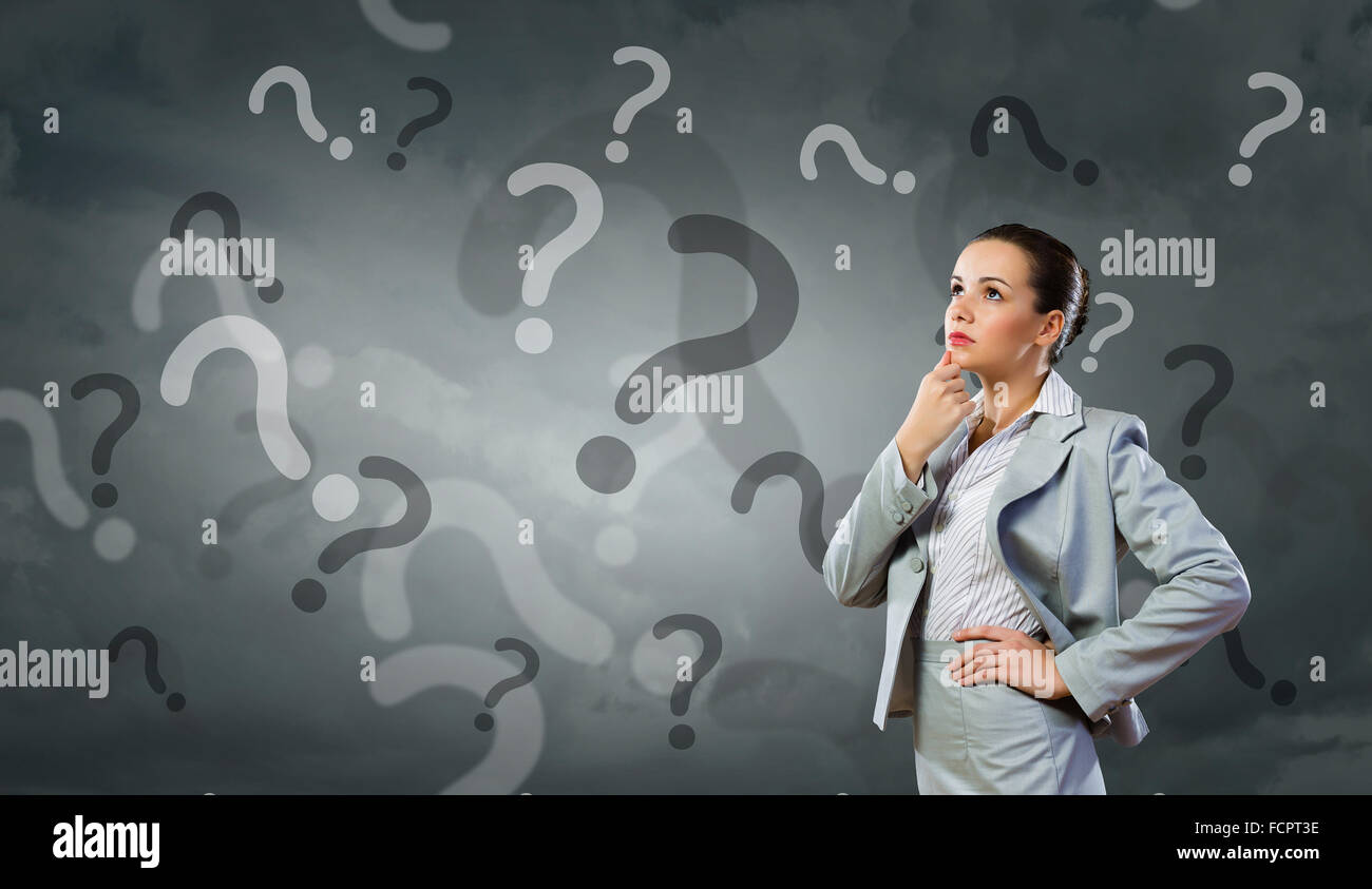Young pretty businesswoman with question mark over head Stock Photo - Alamy