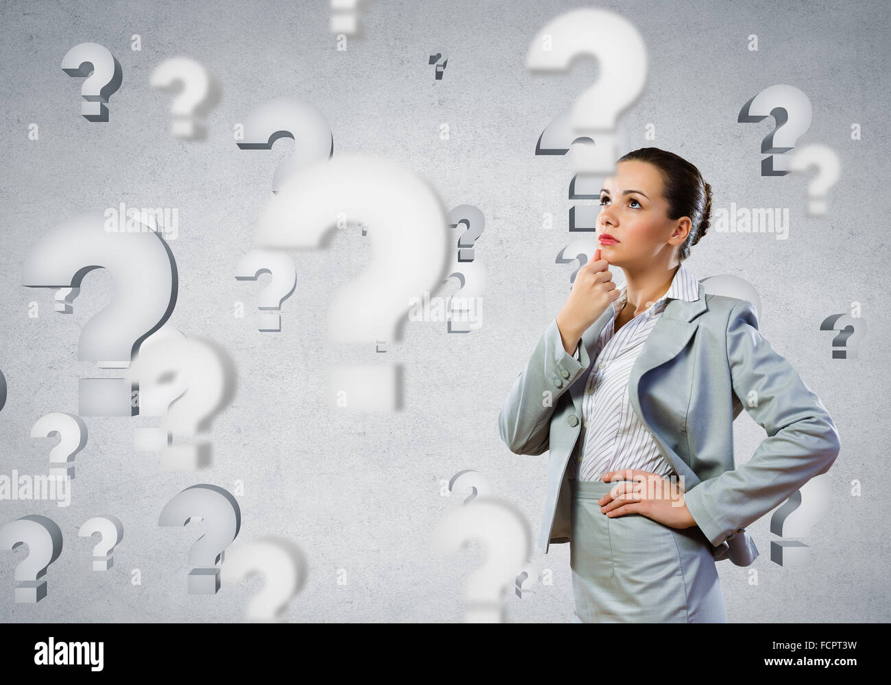 Young pretty businesswoman with question mark over head Stock Photo - Alamy