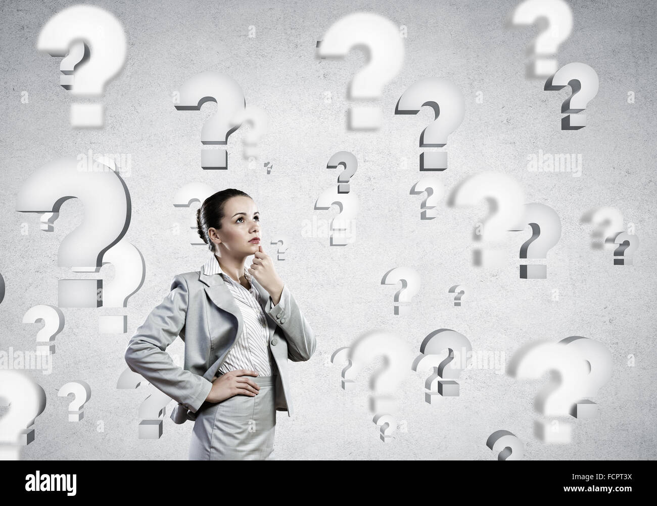 Young pretty businesswoman with question mark over head Stock Photo - Alamy