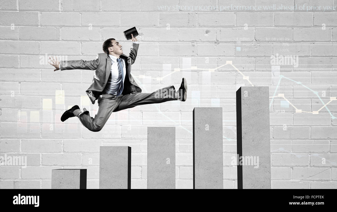 Young businessman stepping up on chart bar Stock Photo - Alamy