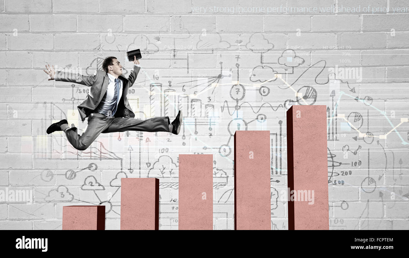 Young businessman stepping up on chart bar Stock Photo - Alamy