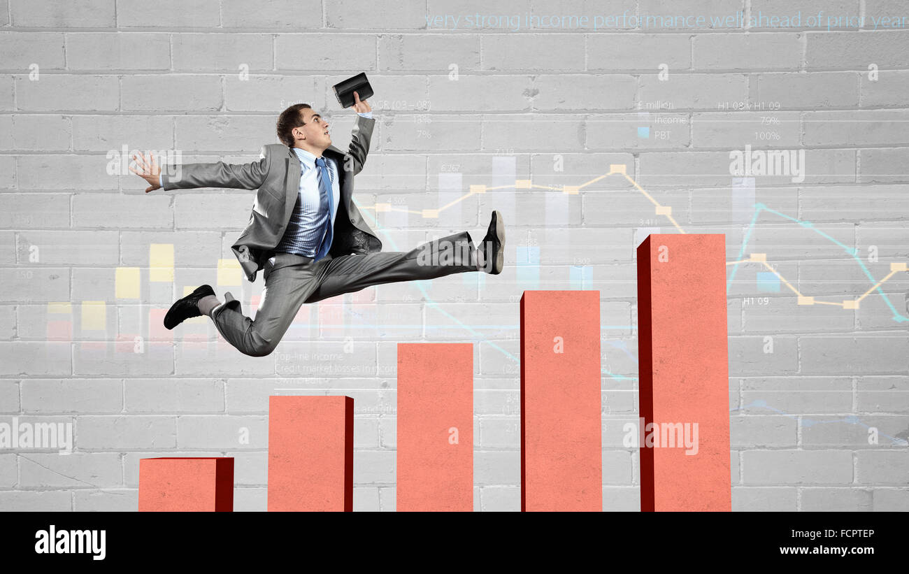 Young businessman stepping up on chart bar Stock Photo - Alamy