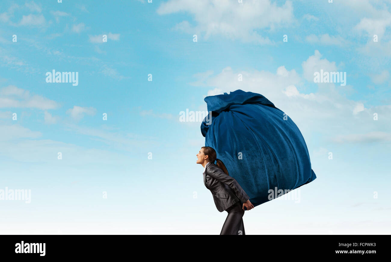 Businesswoman carrying big heavy bag on back Stock Photo - Alamy