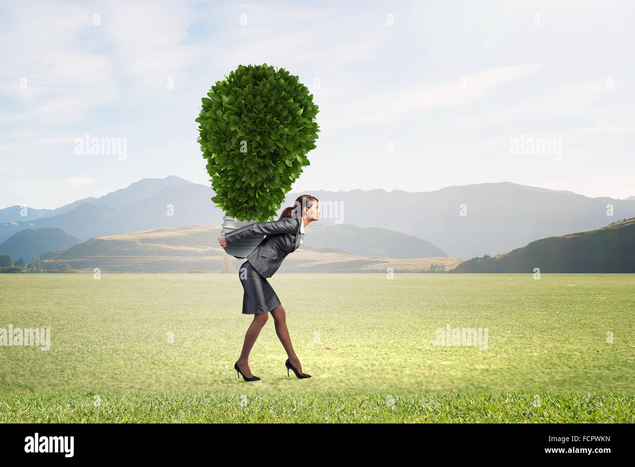 Young businesswoman carrying big light bulb in hands Stock Photo - Alamy