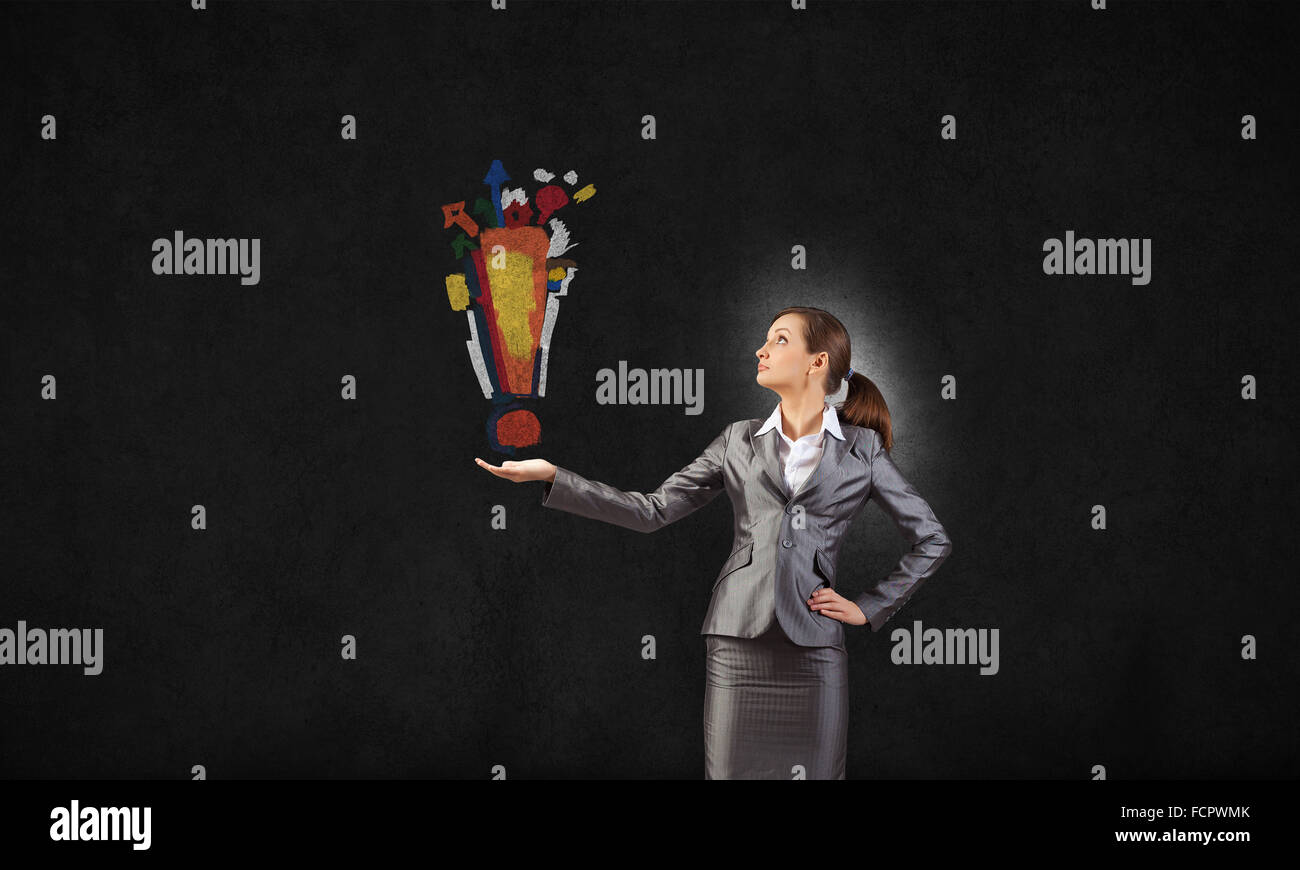 Young businesswoman holding exclamation mark in palm hi-res stock ...