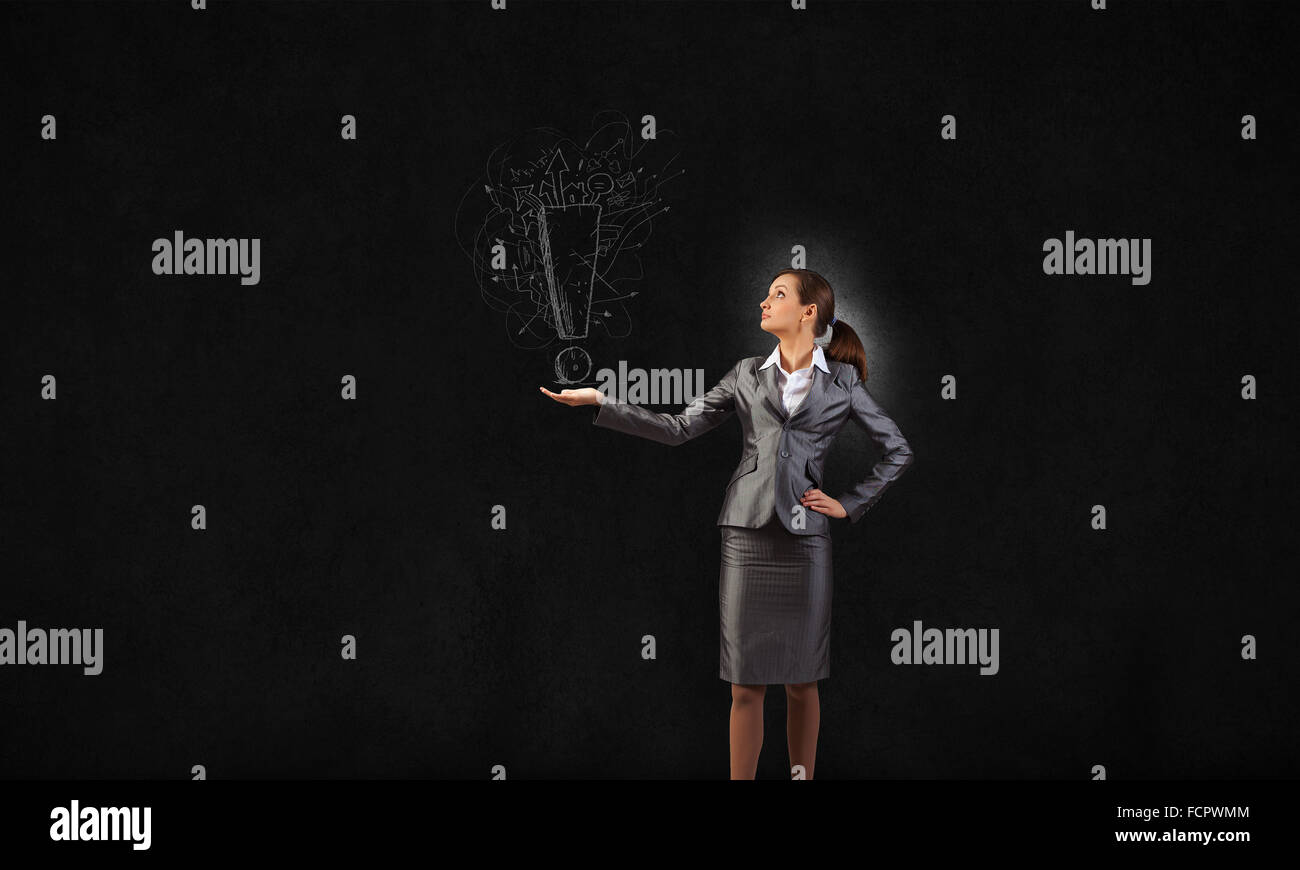 Young businesswoman holding exclamation mark in palm hi-res stock ...
