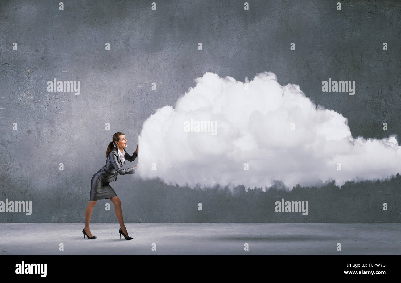 Attractive businesswoman pushing big cloud with effort Stock Photo - Alamy