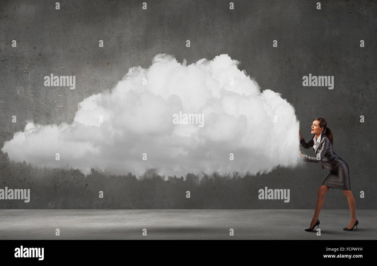 Attractive businesswoman pushing big cloud with effort Stock Photo - Alamy