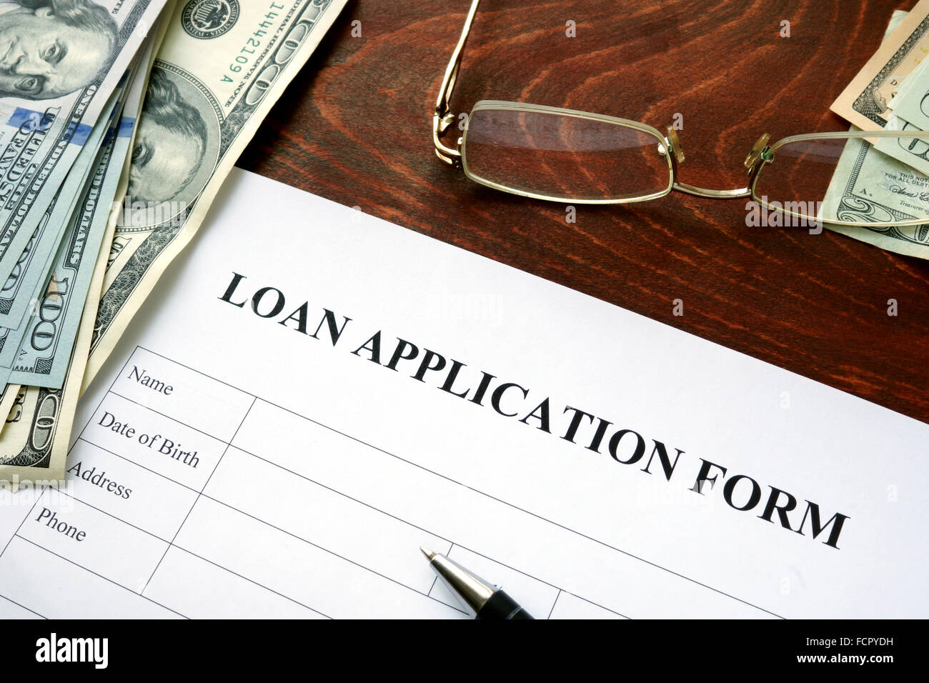 Loan application form on a wooden table Stock Photo - Alamy