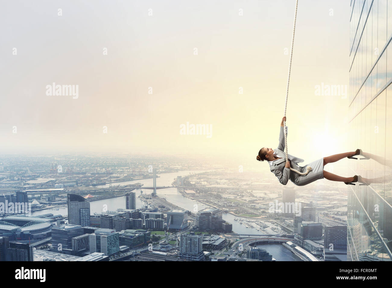 Concept of competition with businesswoman climbing office building with ...