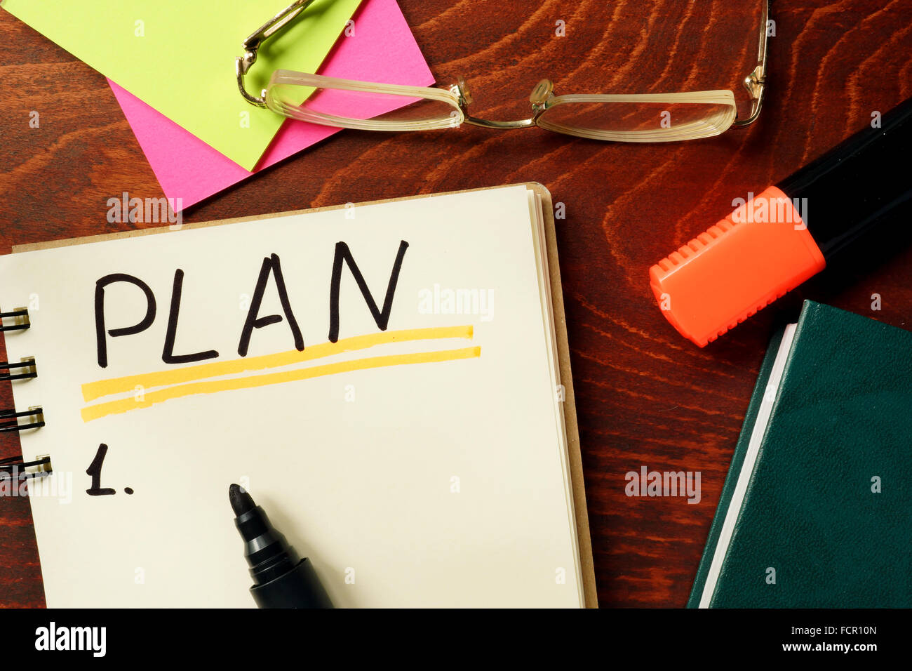 Notepad with plan on the wooden table Stock Photo - Alamy