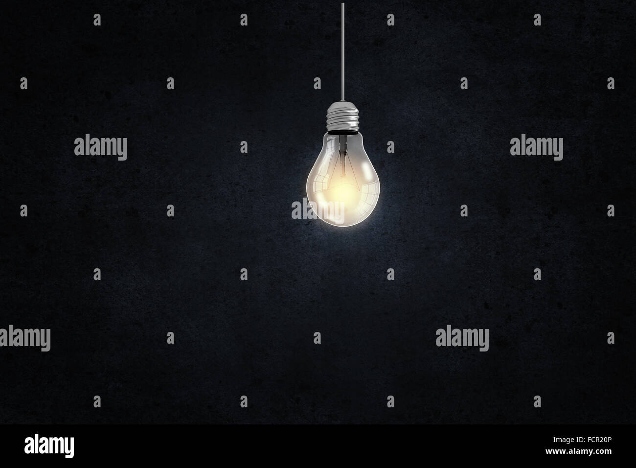 Illuminating hanging light bulb on dark background Stock Photo - Alamy