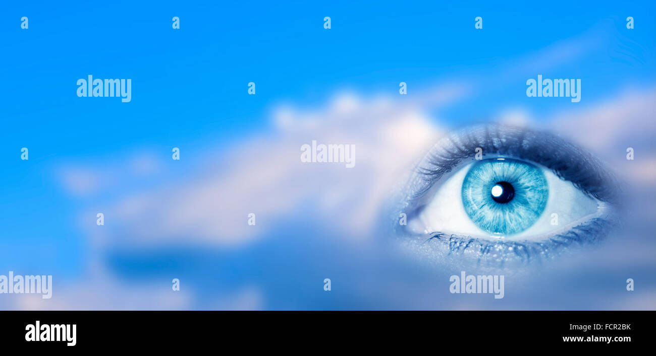 Female clear eye on blue sky background Stock Photo - Alamy
