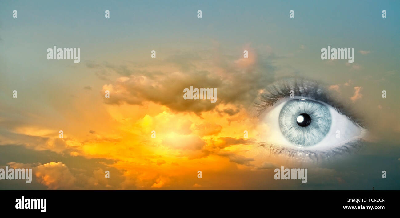 Female clear eye on blue sky background Stock Photo - Alamy
