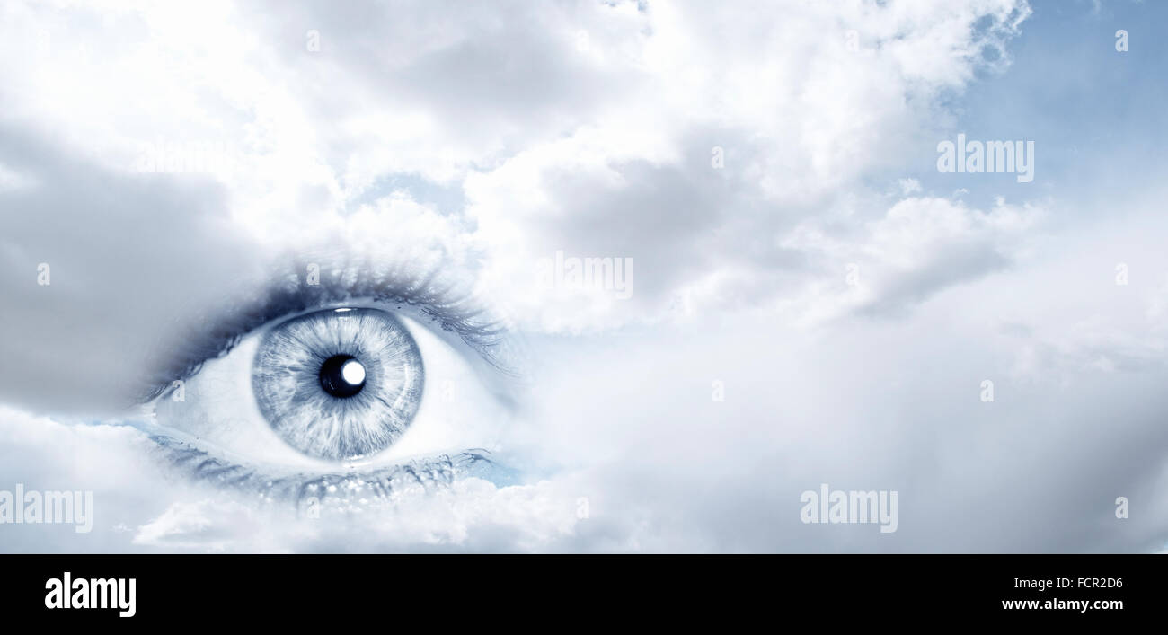 Female clear eye on blue sky background Stock Photo - Alamy