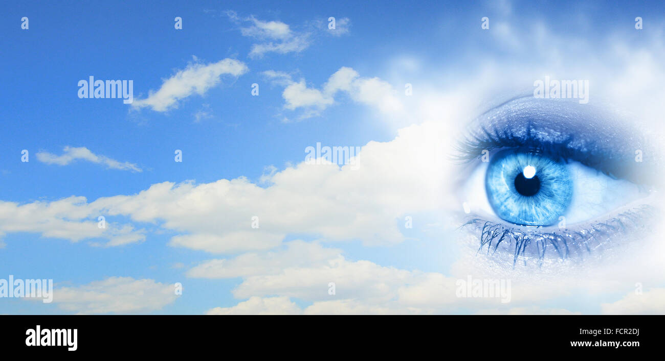 Female clear eye on blue sky background Stock Photo - Alamy