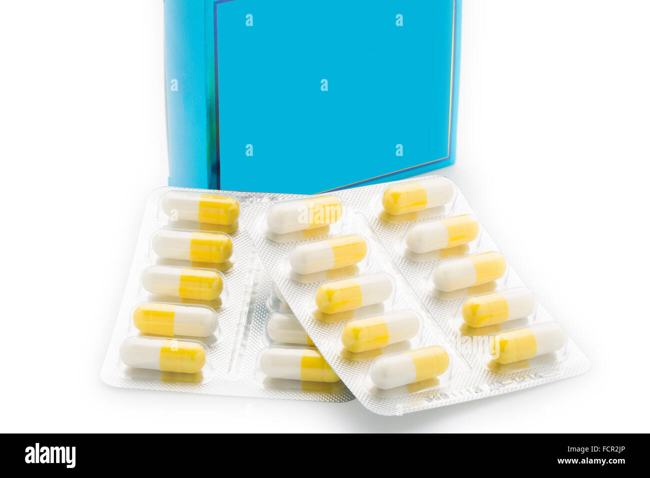 Yellow capsules tablet blister pack and blue pill box Stock Photo - Alamy