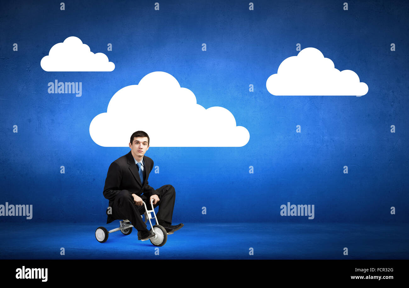 Young handsome businessman riding three wheeled bicycle Stock Photo - Alamy