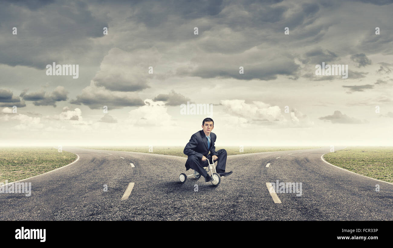 Young handsome businessman riding three wheeled bicycle Stock Photo - Alamy