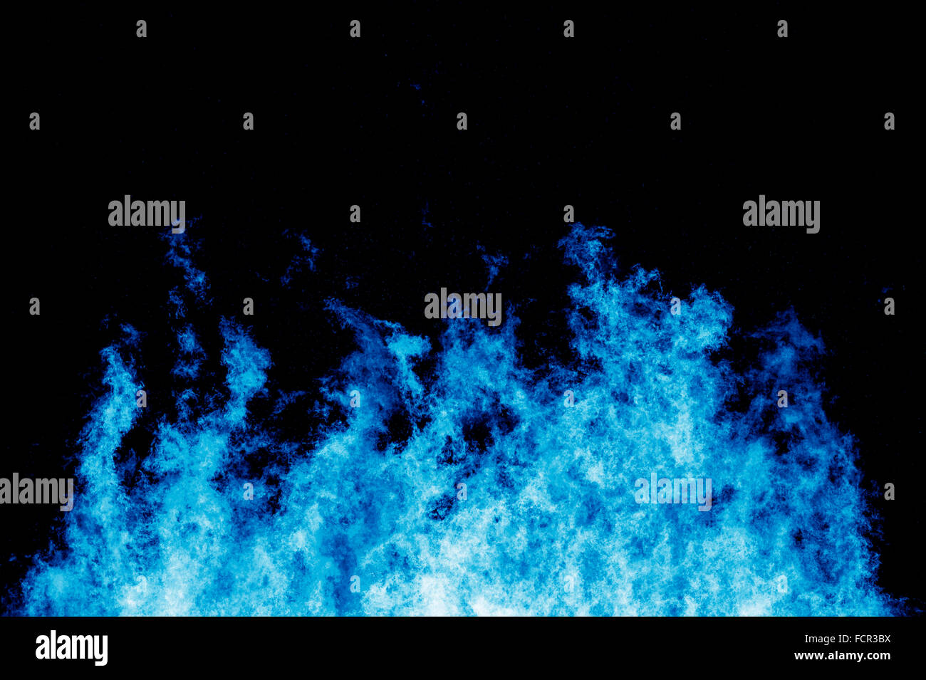 Raging blue fire shot at a high shutterspeed to freeze the motion of ...