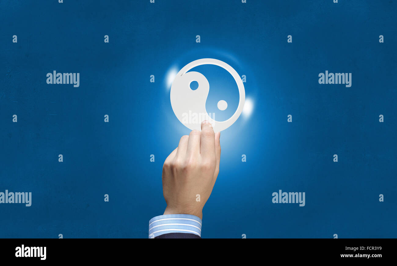Close up of human hand with yin yang concept icon Stock Photo - Alamy