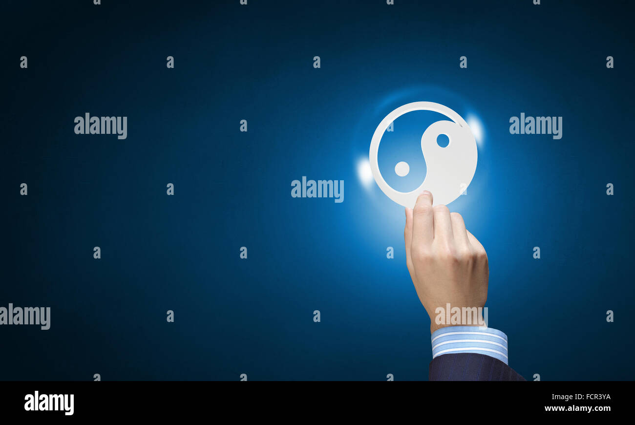 Close up of human hand with yin yang concept icon Stock Photo - Alamy
