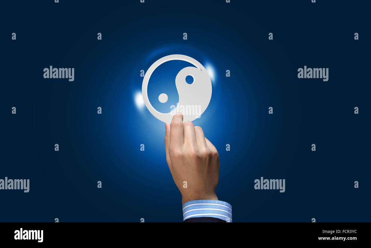 Close up of human hand with yin yang concept icon Stock Photo - Alamy