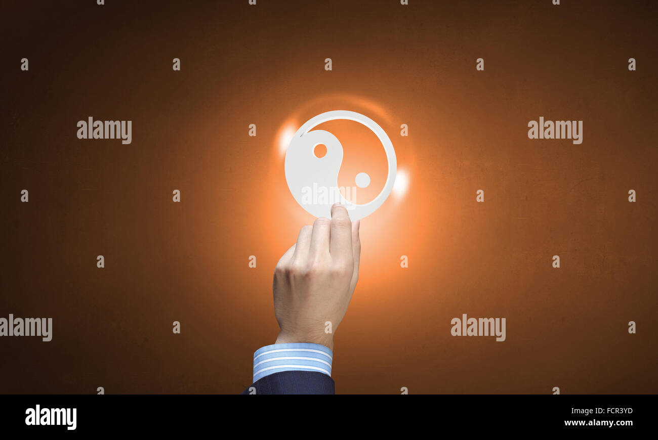Close up of human hand with yin yang concept icon Stock Photo - Alamy
