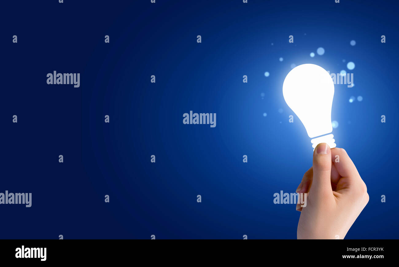 Close up of human hand holding light bulb Stock Photo - Alamy