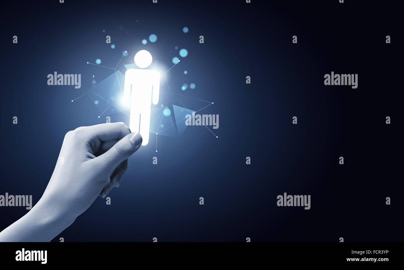 Close up of hand holding male digital figure Stock Photo - Alamy