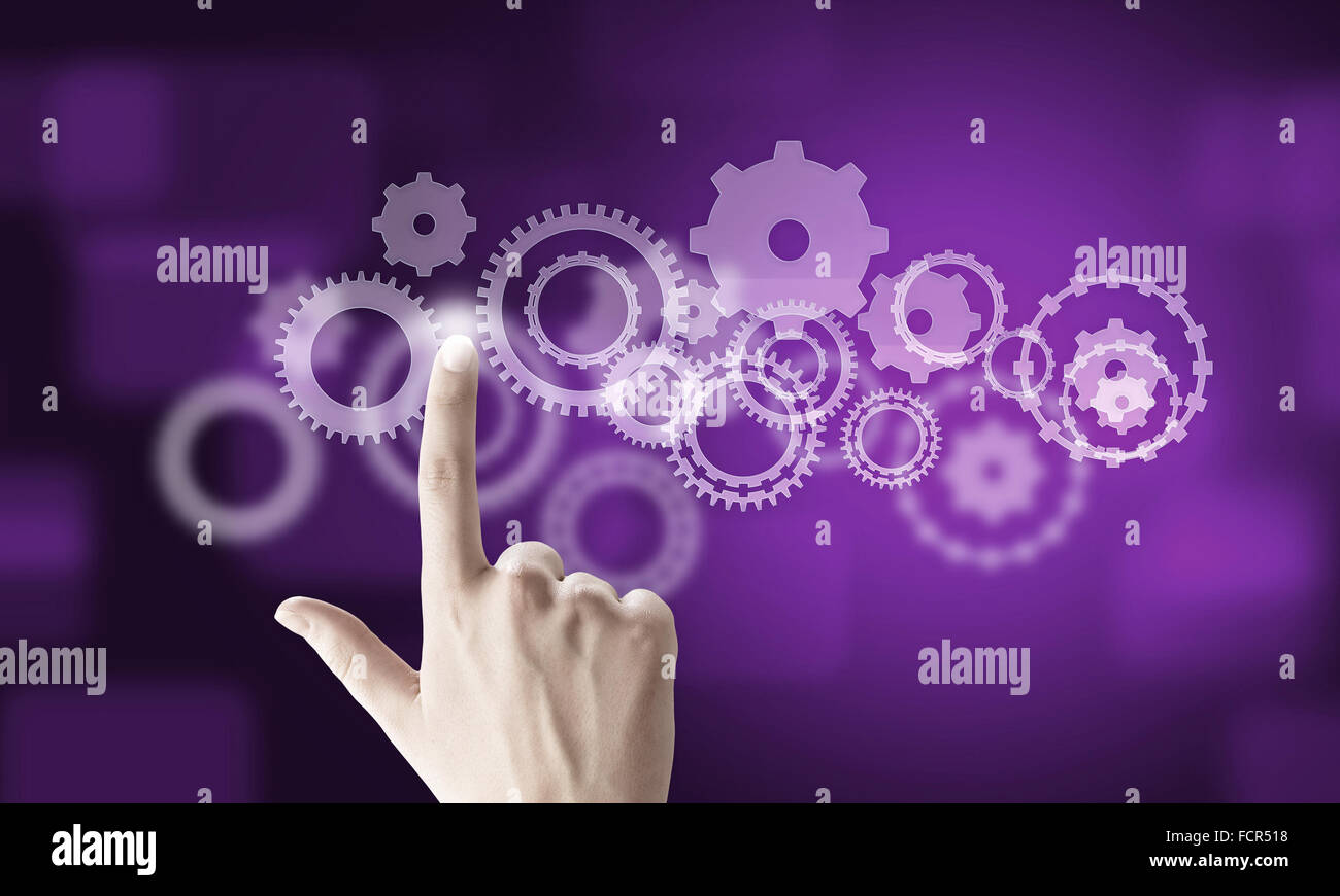 Close up human hand pointing at gears mechanism Stock Photo - Alamy