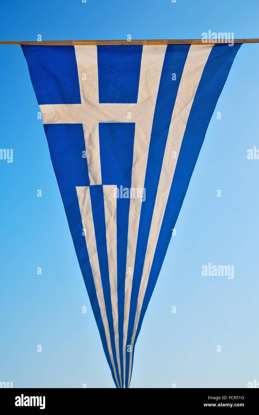 waving greece flag in the blue sky and flagpole Stock Photo - Alamy