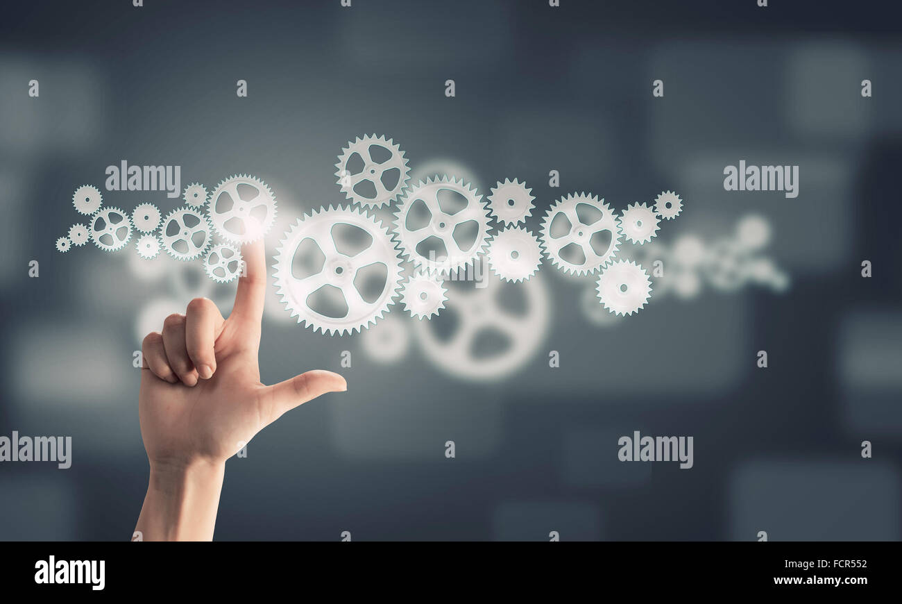 Close up human hand pointing at gears mechanism Stock Photo - Alamy