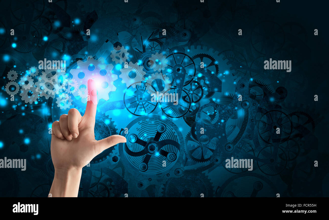 Close up human hand pointing at gears mechanism Stock Photo - Alamy
