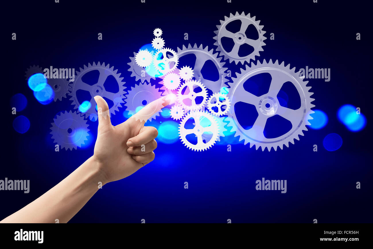 Close up human hand pointing at gears mechanism Stock Photo - Alamy