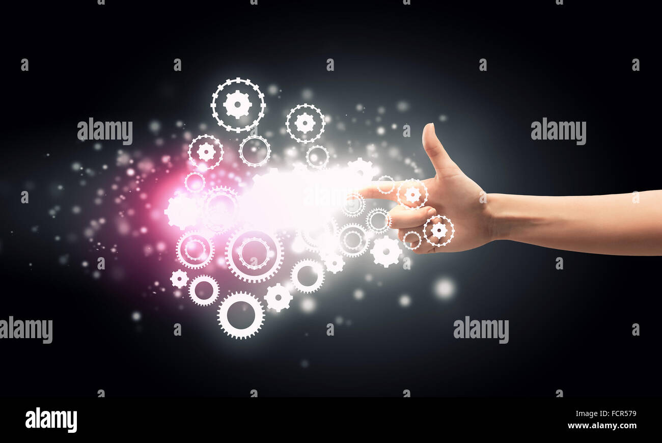 Close up human hand pointing at gears mechanism Stock Photo - Alamy
