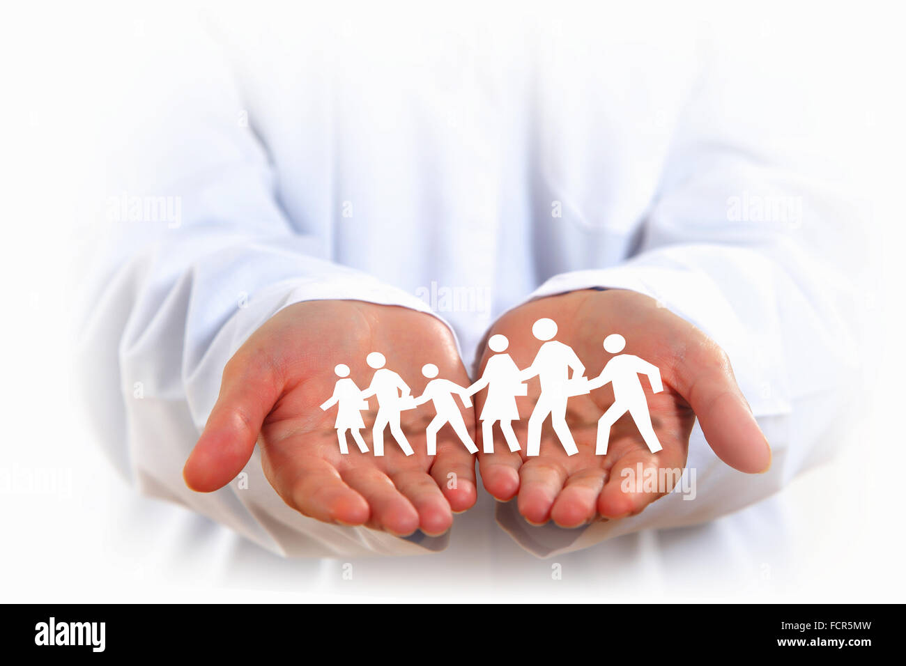 Close up of human hands with row of people figures Stock Photo - Alamy