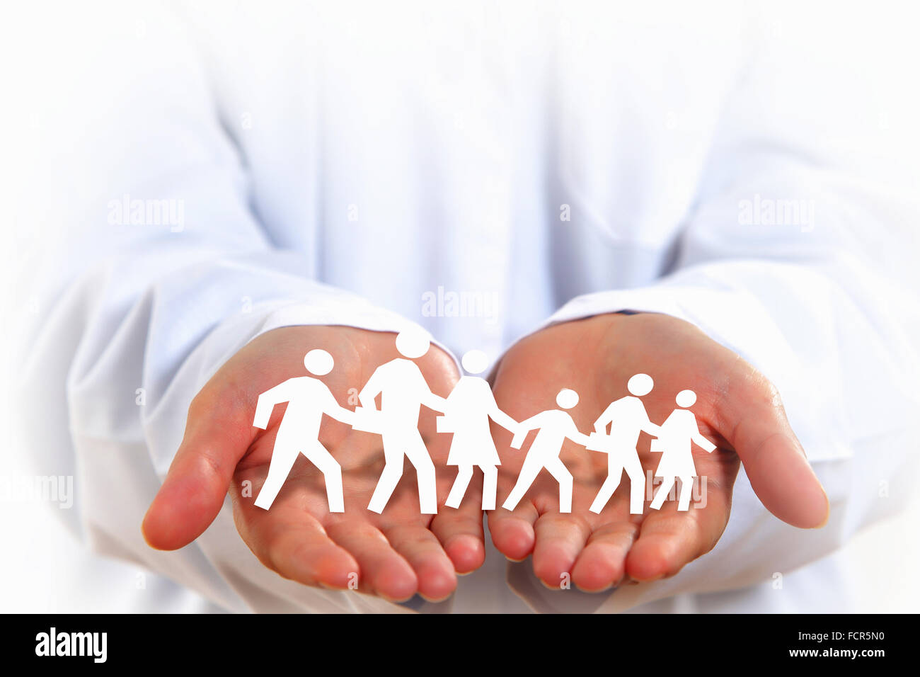 Close up of human hands with row of people figures Stock Photo - Alamy