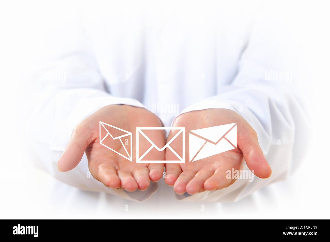 Close up of human hands with mail white symbols Stock Photo - Alamy