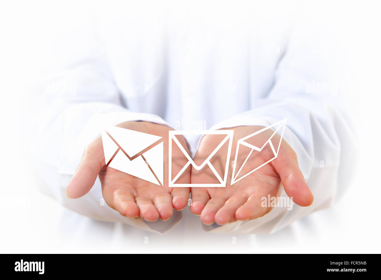 Close up of human hands with mail white symbols Stock Photo - Alamy